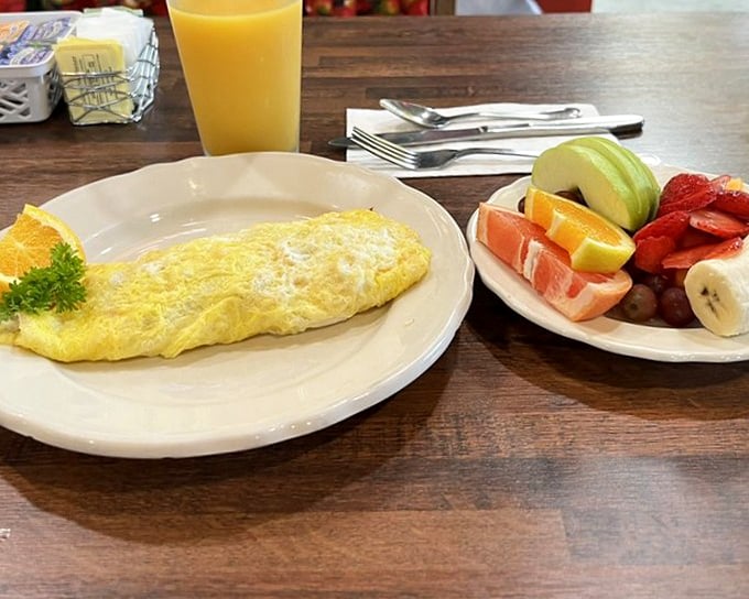 Perfect omelet paired with fresh fruit—because balance is everything, even in comfort food paradise.