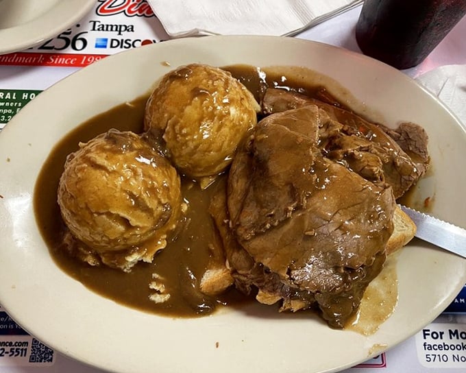 Open-faced roast beef swimming in gravy so good you'll consider asking for a straw—comfort food that hugs you from the inside.