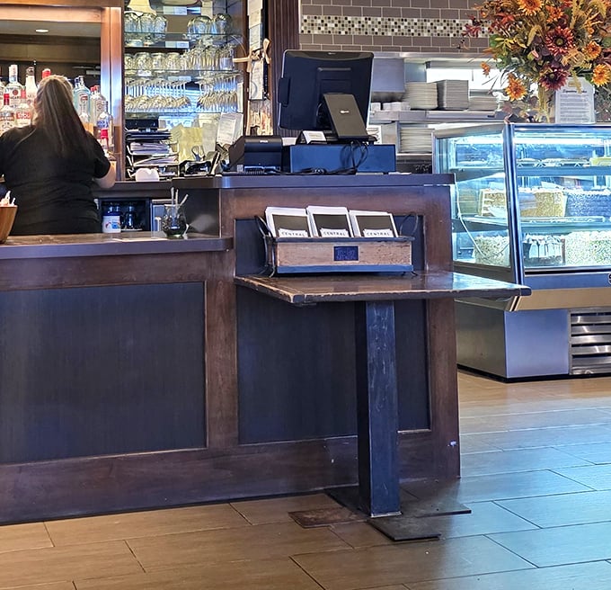 The dessert case stands like a trophy display of sweet achievements. Each cake waiting patiently for its moment in the spotlight.