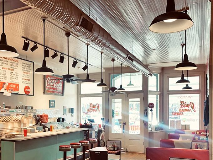 Sunlight streams through windows illuminating a diner space that feels both timeless and essential—where conversations flow as easily as the coffee.