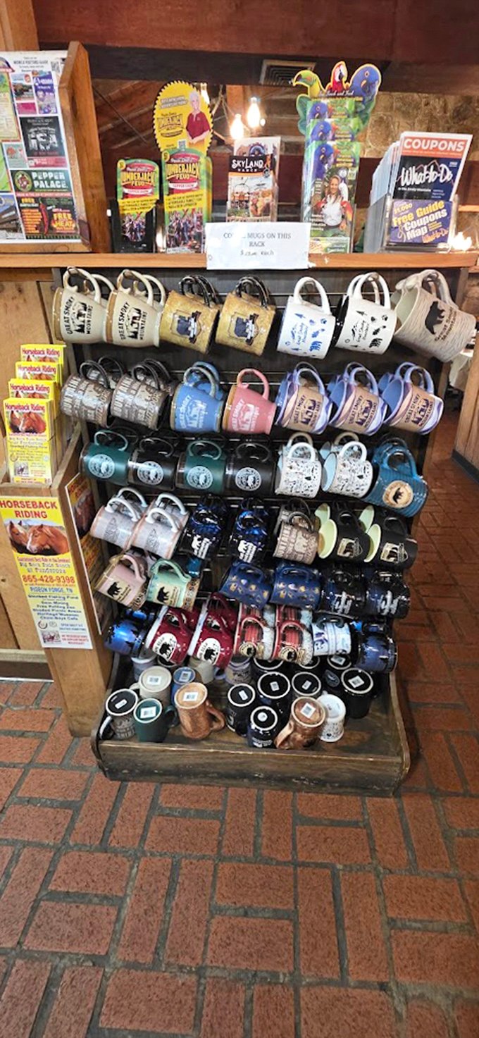 Souvenir mugs lined up like eager contestants—each one hoping to be your chosen vessel for morning coffee memories.