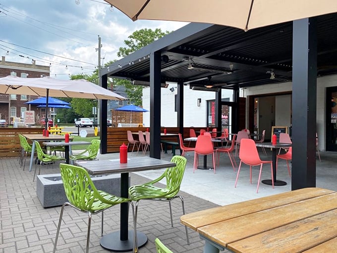 The outdoor patio, with its cheerful green chairs and covered seating, offers a breath of fresh air without sacrificing style points.