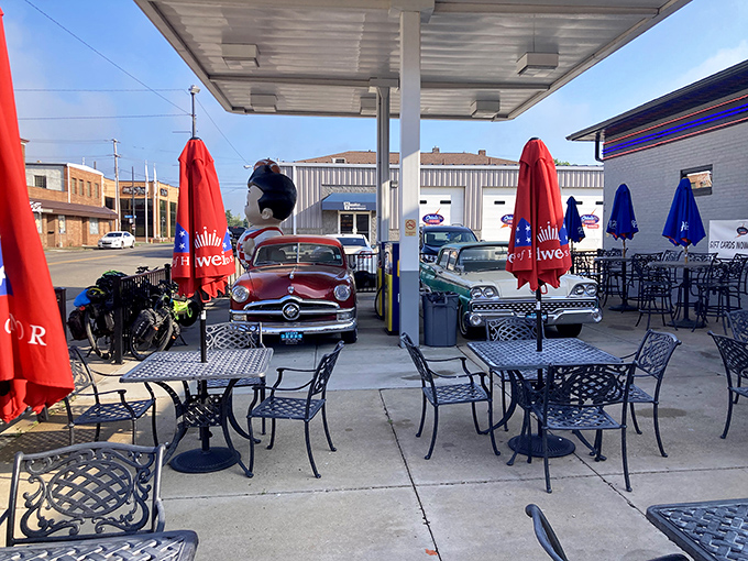 The outdoor seating area doubles as a classic car showcase—because nothing complements breakfast like vintage automotive eye candy.