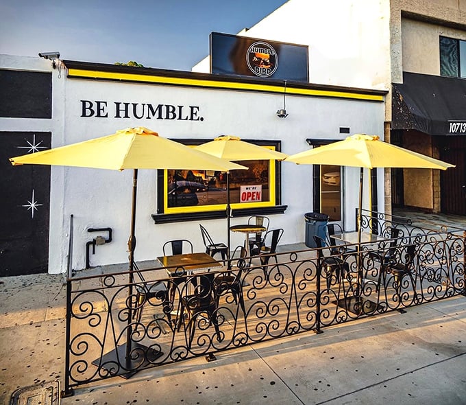 Three yellow umbrellas standing guard over the sidewalk patio – California sunshine meets Nashville heat in perfect harmony.