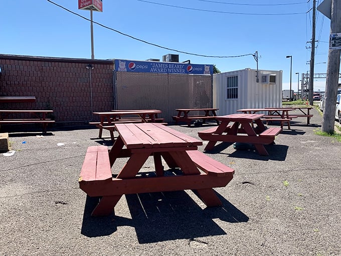 The outdoor dining room where weather becomes part of the experience. These picnic tables have witnessed more food euphoria than most five-star dining rooms.