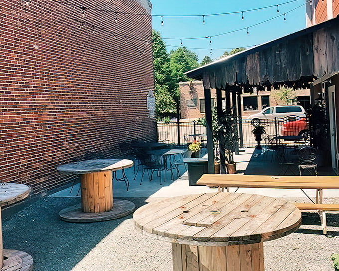 Summer in Wisconsin means outdoor seating where string lights twinkle above wooden spools repurposed as tables—small-town ingenuity at its finest.