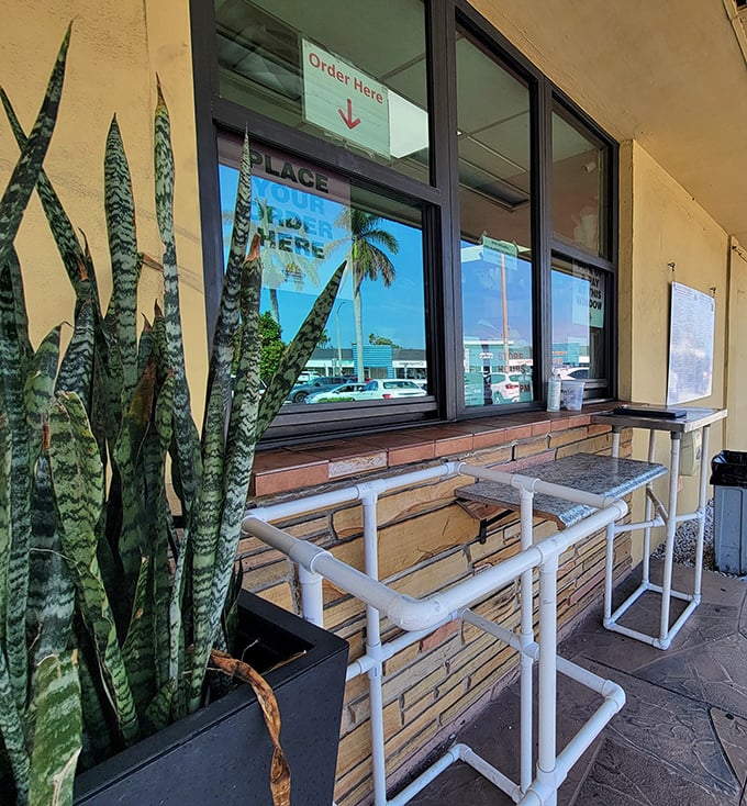 The takeout window—where hope springs eternal for those who need their bagel fix without the commitment of sitting down.