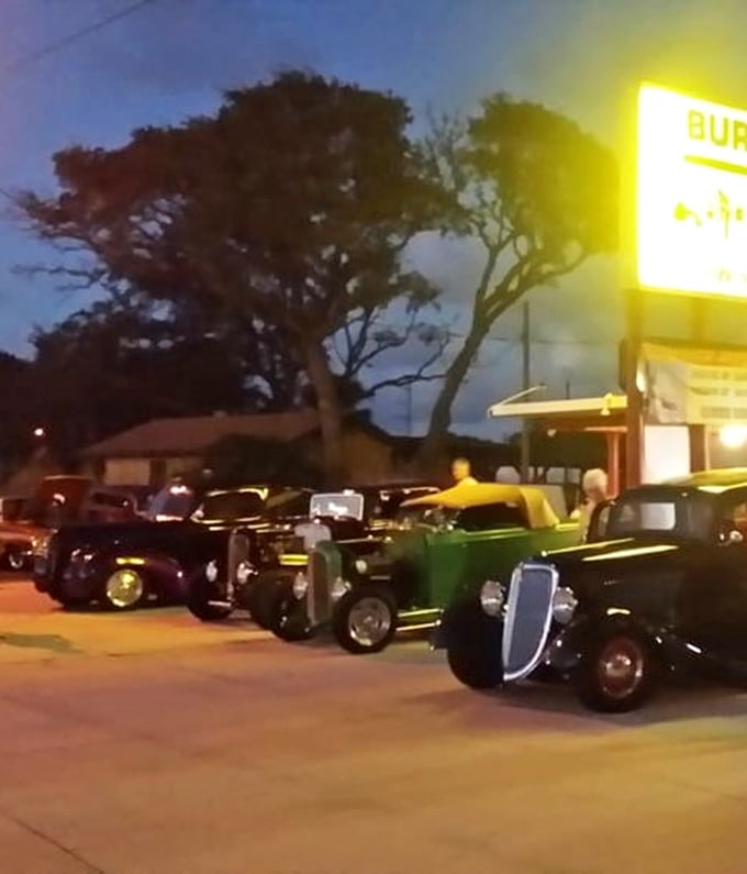 Classic cars gathering under the glow of the Burger Inn sign—a scene Norman Rockwell would've painted if he'd had a serious craving for onion rings.