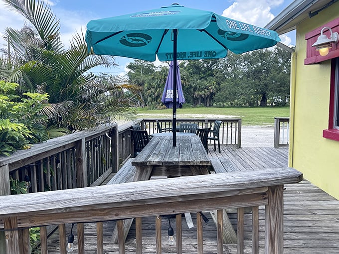 Florida dining done right—an outdoor deck where the breeze carries conversations and the umbrella shields you from the sunshine state's namesake.