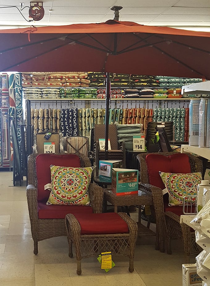 Patio paradise under a terra cotta umbrella – wicker chairs and vibrant pillows create backyard escapes for a fraction of specialty store prices.