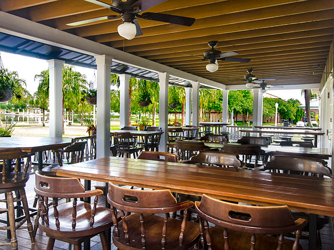 Florida dining done right—covered outdoor seating where gentle ceiling fans keep the air moving while you contemplate which cut of beef will make your evening complete.
