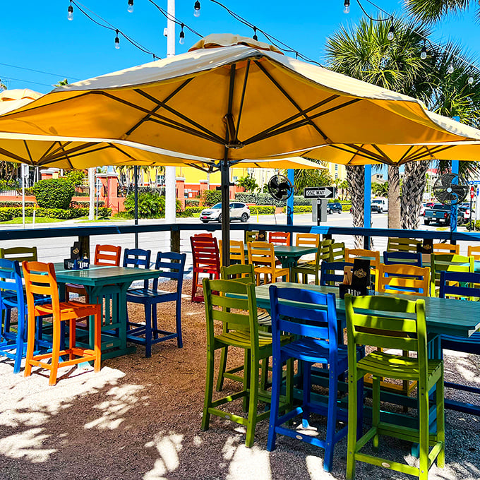 Rainbow-hued chairs under golden umbrellas—outdoor seating that's as cheerful as a Florida sunrise and twice as inviting.