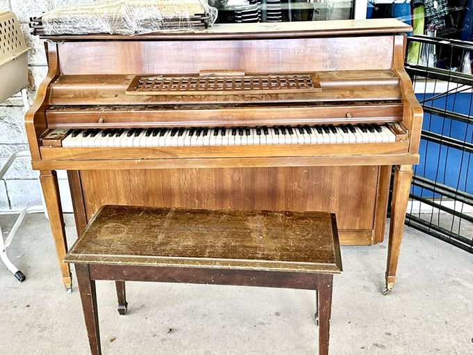 A vintage piano sits patiently, holding decades of music within its wooden frame, waiting for new fingers to bring it back to life.