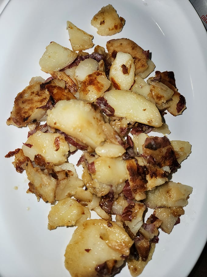 These home fries are the unsung heroes of breakfast—crispy edges, tender centers, with bits of onion playing hide and seek throughout.