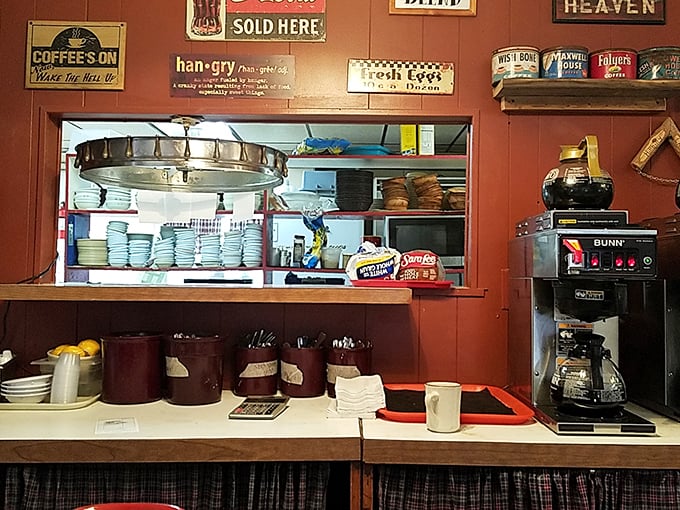 The kitchen pass reveals the beating heart of the operation—stacked plates ready for action and a coffee maker that never gets a day off. Americana in its natural habitat.