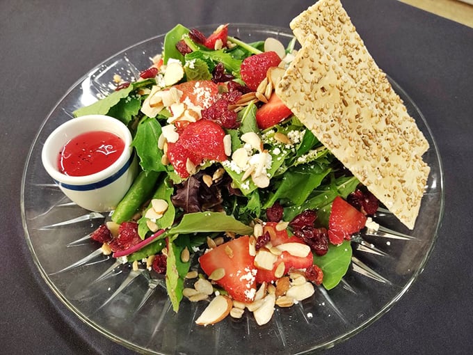 This vibrant salad proves healthy eating needn't be boring – strawberries, almonds, and greens create a colorful composition worthy of the crystal plate it's served on.