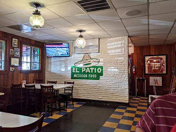 The white brick wall proudly displays the El Patio logo—a simple reminder that you're in a place that understood Tex-Mex before it was cool.