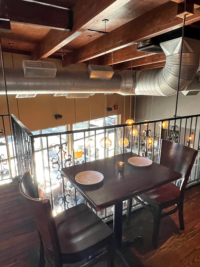 Second-floor seating offers a bird's-eye view of the dining room below – perfect for romantic dinners or discreet people-watching.