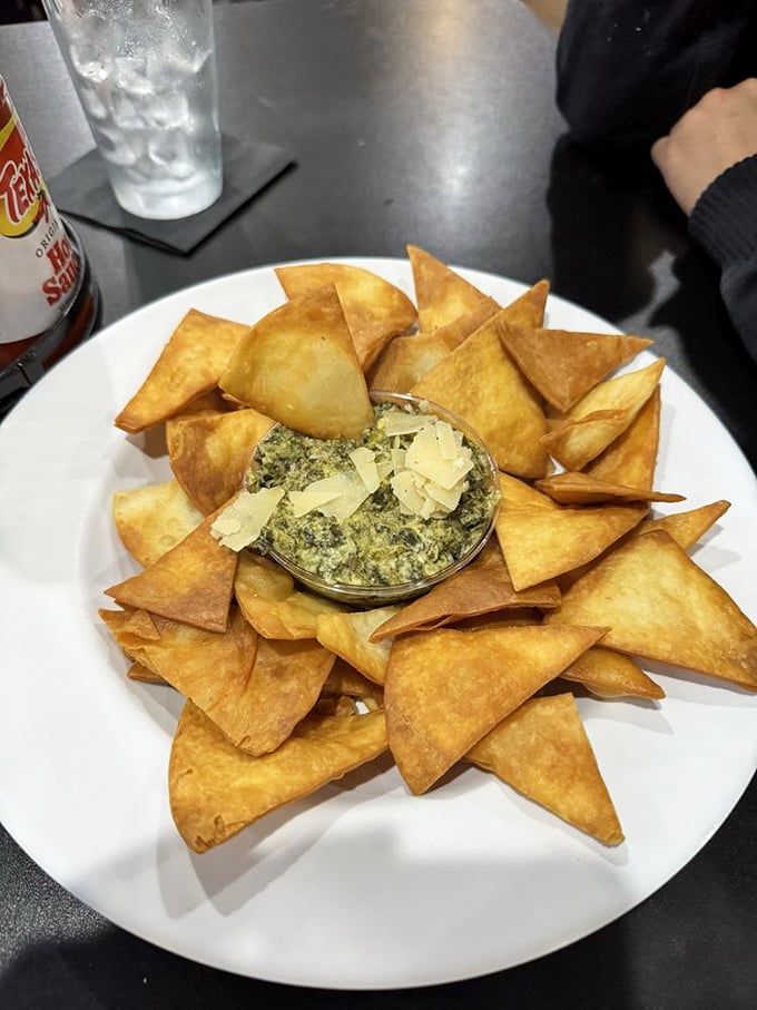 This spinach dip surrounded by crispy triangles isn't just an appetizer—it's an edible work of art that disappears faster than you can say "more please."