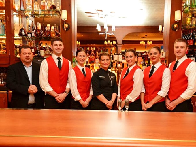 The staff lineup in their signature red vests—the A-team you want handling your carnivorous adventure.