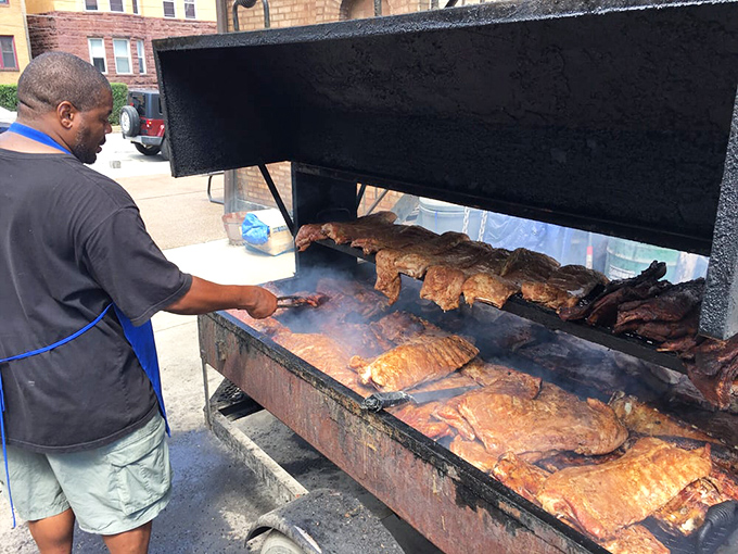 A pitmaster tending to his craft. Like a conductor leading an orchestra, every movement is purposeful, every timing decision crucial.
