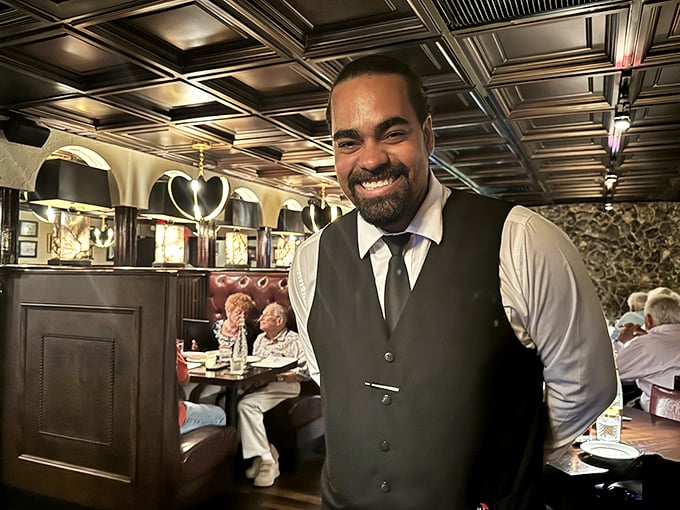 The smile says it all—service with genuine warmth rather than corporate-mandated cheer. A true hospitality professional.