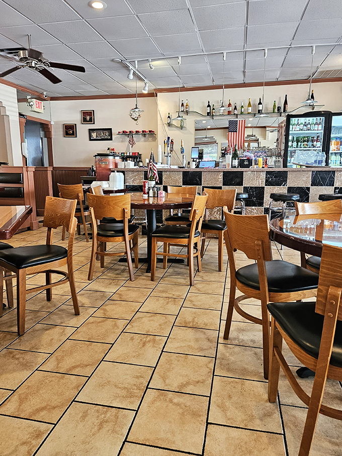 Tables arranged with mathematical precision create an atmosphere where both intimate conversations and boisterous family gatherings can coexist peacefully.