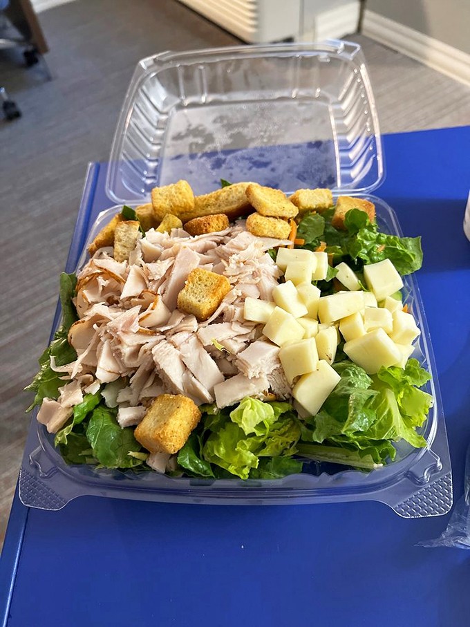 Fresh turkey salad on greens, proving they can do light and healthy when the mood strikes.