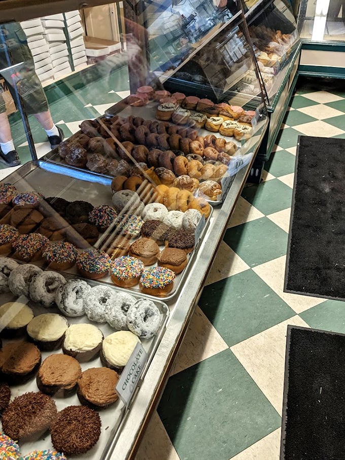 The display case at Oram's is like a museum of happiness, each tray offering a different path to sugary bliss.