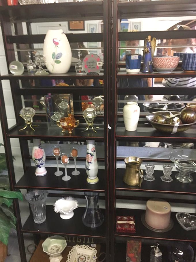 The glassware display cases – museum-worthy collections of everyday elegance where vintage vases and crystal wait for their second act.