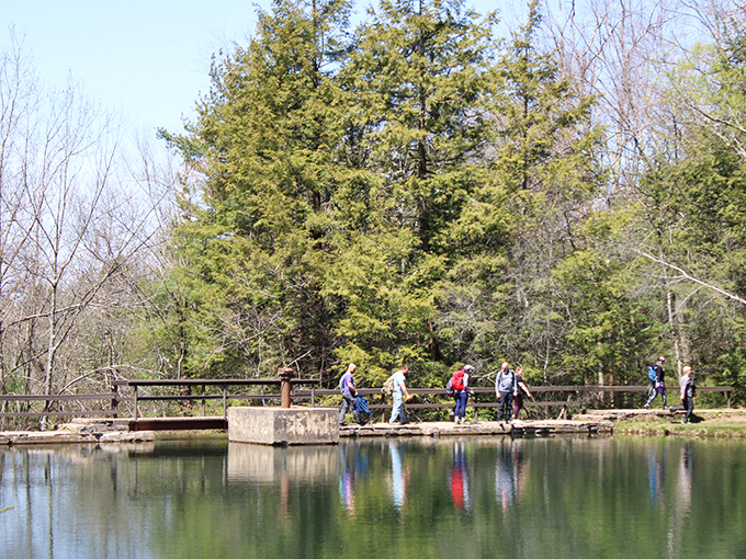 Hikers enjoy the serenity of the park's many peaceful ponds. Their reflections double the beauty in nature's perfect mirror.