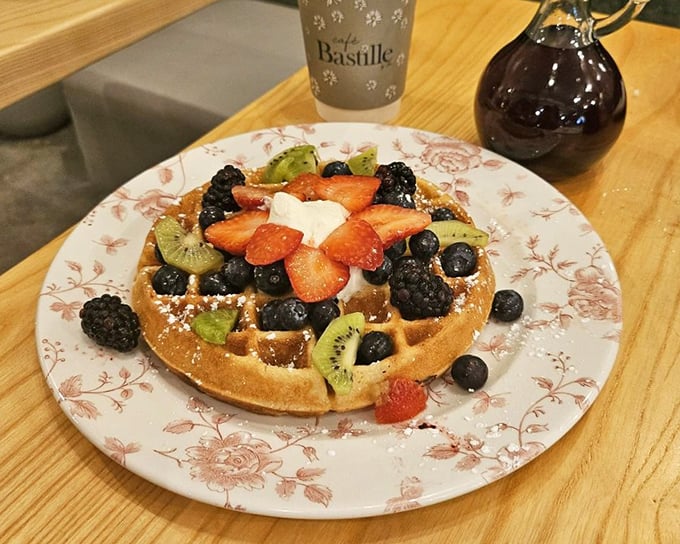 This waffle doesn't just have fruit on top—it's hosting a berry convention with strawberries, blueberries, and kiwi all vying for your attention.