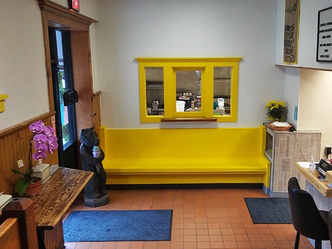 The cheerful yellow entryway—like stepping into breakfast sunshine. Even the bear statue looks happy to be here.
