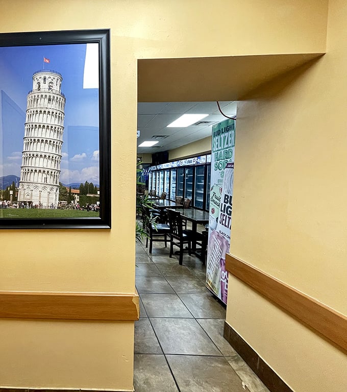 A framed Leaning Tower of Pisa watches over the entrance to the dining area—a nod to Italian heritage in this Pittsburgh pizza paradise.