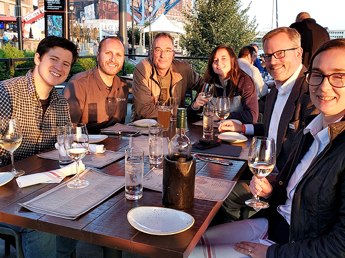 The patio at sunset is where memories are made. Notice how everyone's wine glasses are half-full—the universal sign of a good time in progress.