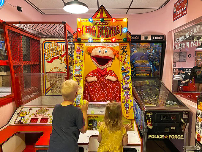 The arcade isn't just games—it's a parenting strategy where kids burn energy while adults debate whether to order another slice of pie.