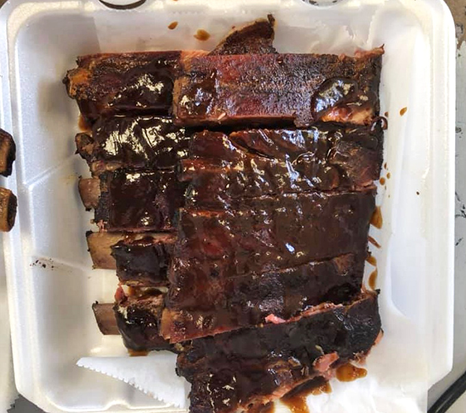 Ribs so perfectly lacquered they look like they've been polished by BBQ angels – the bark alone deserves its own fan club.