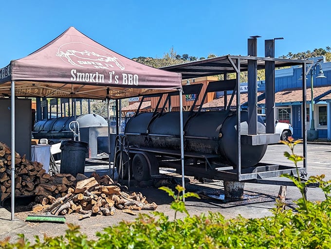 The mothership: where smoke meets meat for hours of low-and-slow transformation. That stack of wood isn't decorative – it's fuel for flavor.