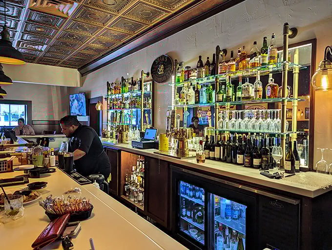 A bar stocked like a liquid library where every bottle tells a different story. The illuminated shelves aren't just practical—they're showcasing liquid possibilities.