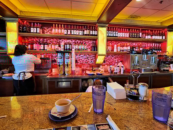 The bar's crimson backlighting creates the perfect dramatic backdrop for deciding between a milkshake or something stronger.