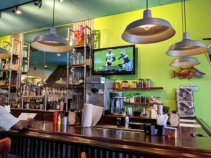 The bar area balances sports-watching with serious eating – those pendant lights have illuminated countless moments of food bliss.