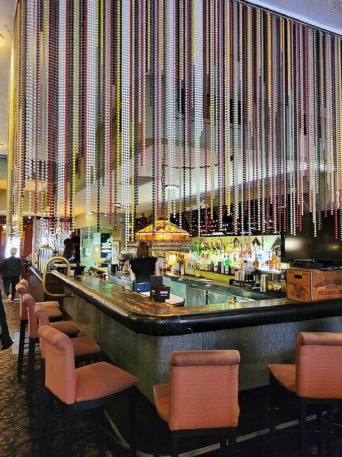 Beaded curtains shimmer in the bar light – a touch of mid-century glamour that makes ordering a Manhattan feel like the most natural thing in the world.