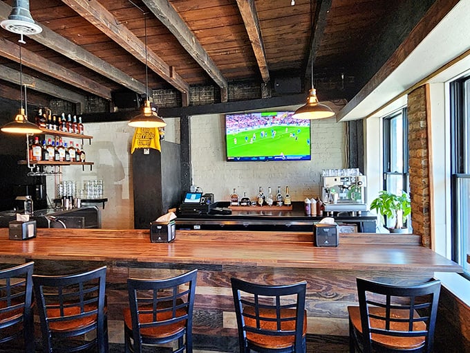 The bar area balances warmth and industrial edge – where craft beers flow and sports play while you contemplate your next barbecue adventure.