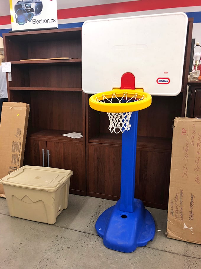 A Little Tikes basketball hoop stands ready for action – because someone's outgrown toy becomes another family's backyard championship court.