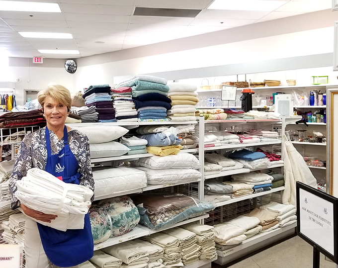 The linen section, where a helpful volunteer stands ready to match your bedroom with the perfect set of gently-loved sheets.