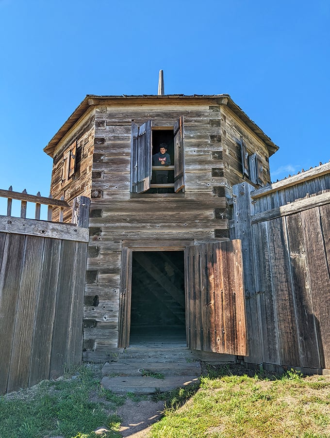 The blockhouse stands guard like a wooden sentinel, its weathered timbers telling tales of frontier life on California's rugged coast.