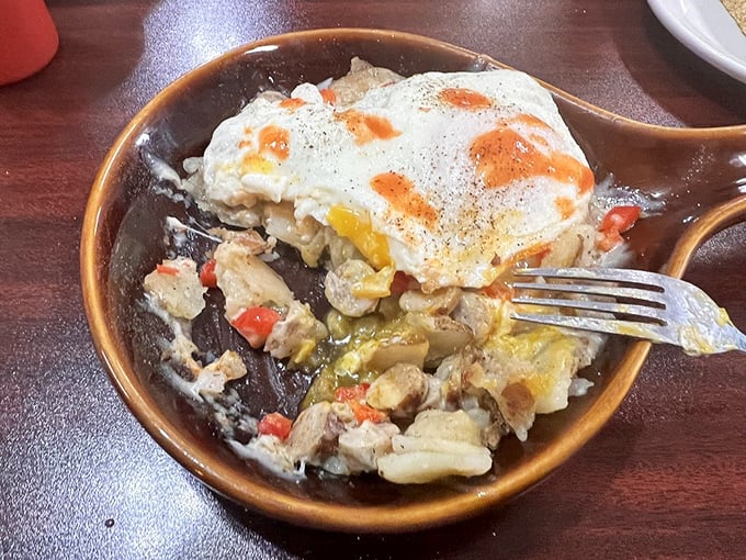 A skillet breakfast with eggs perched atop a savory medley. When breakfast components unite in one dish, everybody wins.