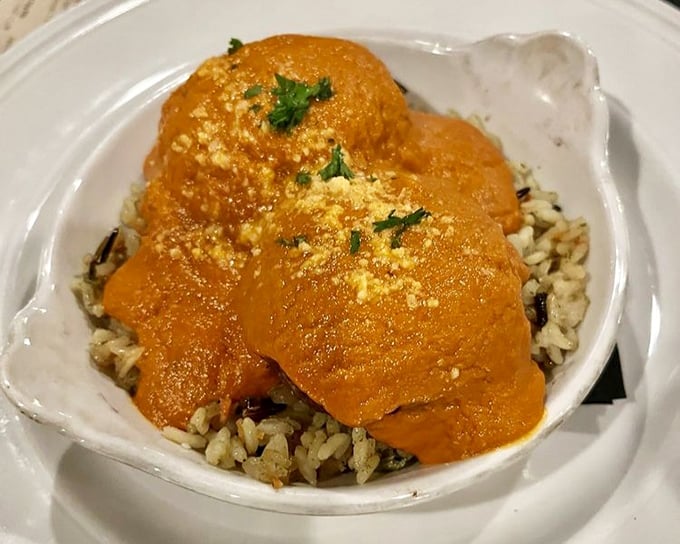 These aren't just meatballs—they're orange-hued flavor bombs nestled on a bed of wild rice, waiting to ambush your taste buds.