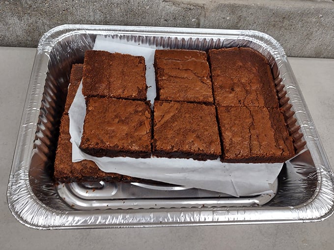 Homemade brownies cut thick and proud – the kind of dessert that makes you reconsider whether you really need that extra BBQ rib.