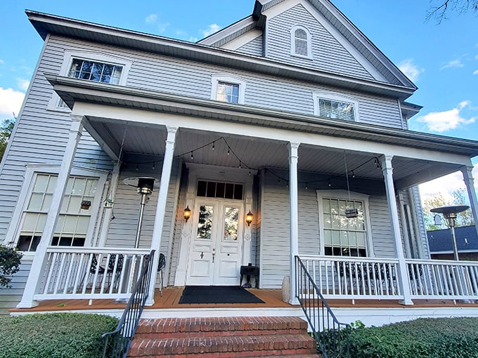This historic home's welcoming porch practically demands you sit a spell – Southern architecture's version of a warm hug.